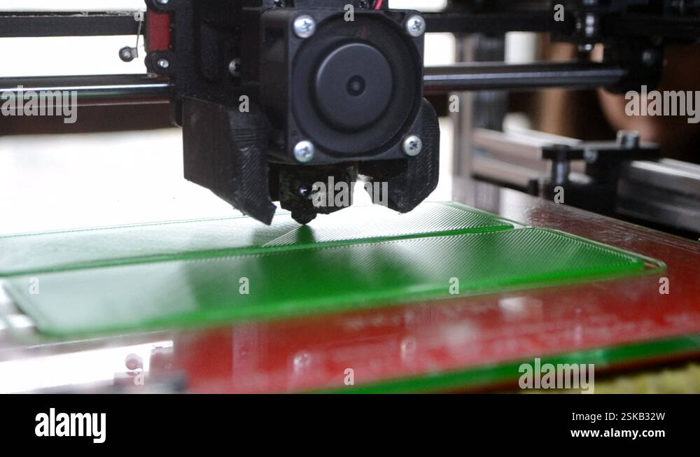 3D printer printing prototype from molten plastic. Process of creating ...