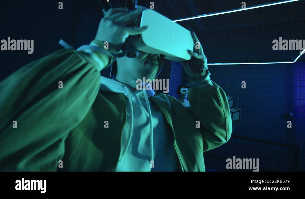 Chinese Guy Putting on VR Headset to Play Fight Game in Dark Arena ...