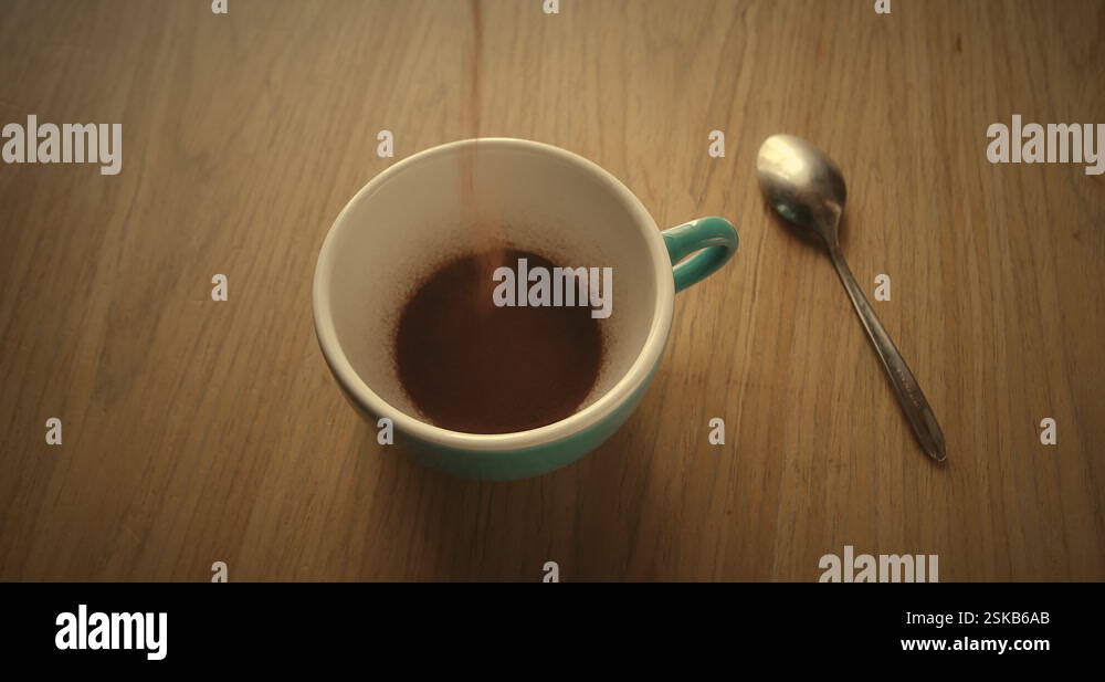 Man Making Instant Coffee freeze-dried coffee dipped into a blue cup ...