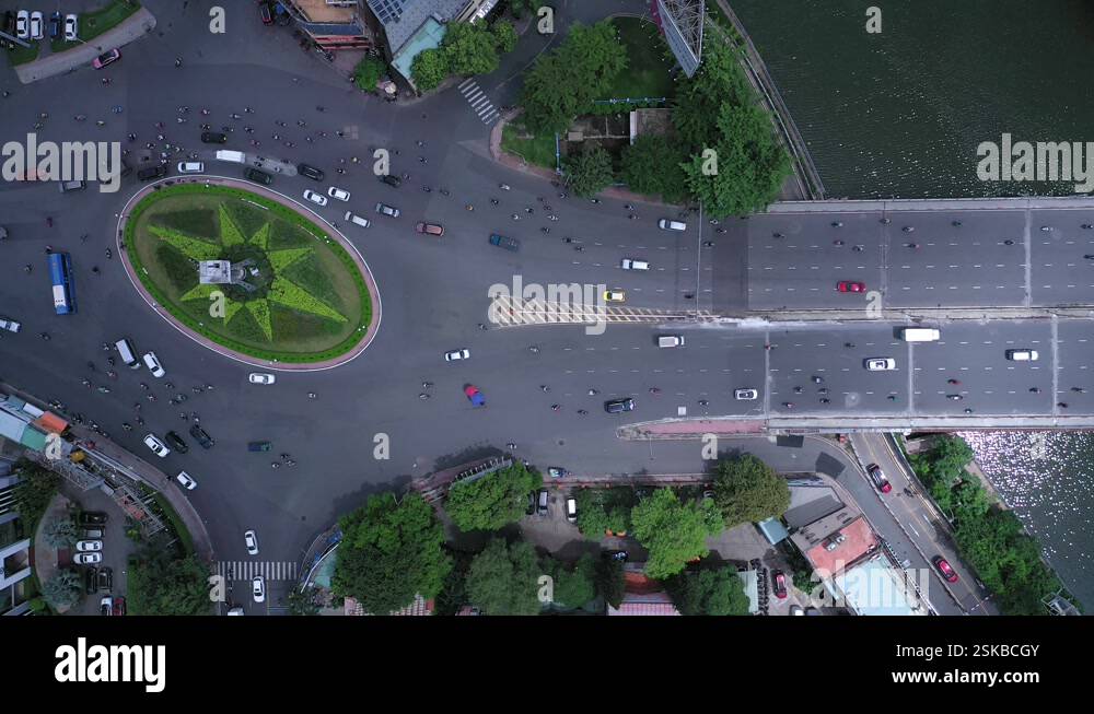 Traffic roundabout and bridge over canal from top down aerial view with ...