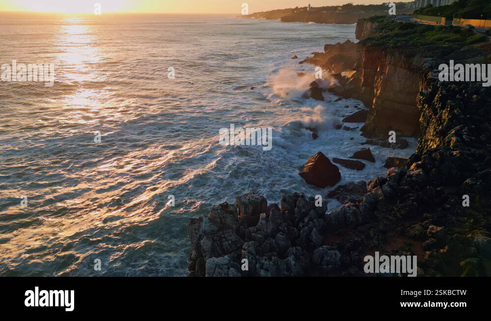 Amazing sunset sky foaming ocean waves washing rocky coast aerial ...