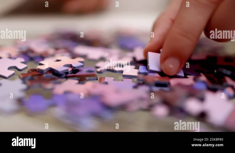 Girl solving a puzzle in her living room in extreme slow motion Stock ...