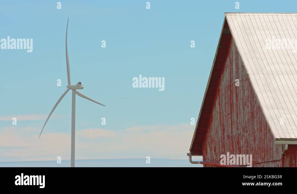 Canadian hydro wind turbine with blades spin. Windmills near food farm ...