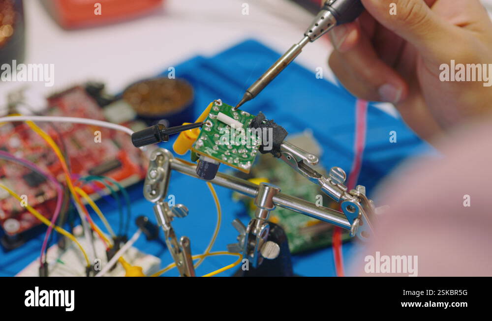 Hands of Man Holding Solder Iron Soldering the Resistor from ...