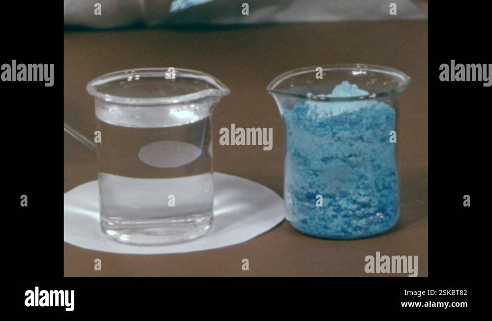 1960s: Scientist scoops blue powder from beaker and adds to another ...