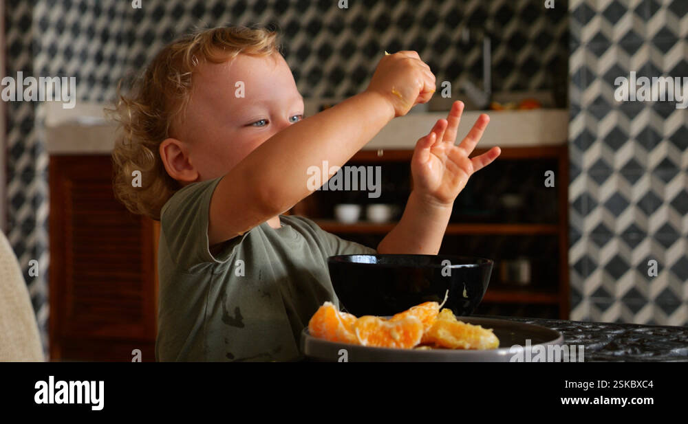 Using only his own hands, baby boy extracts little amount of orange ...