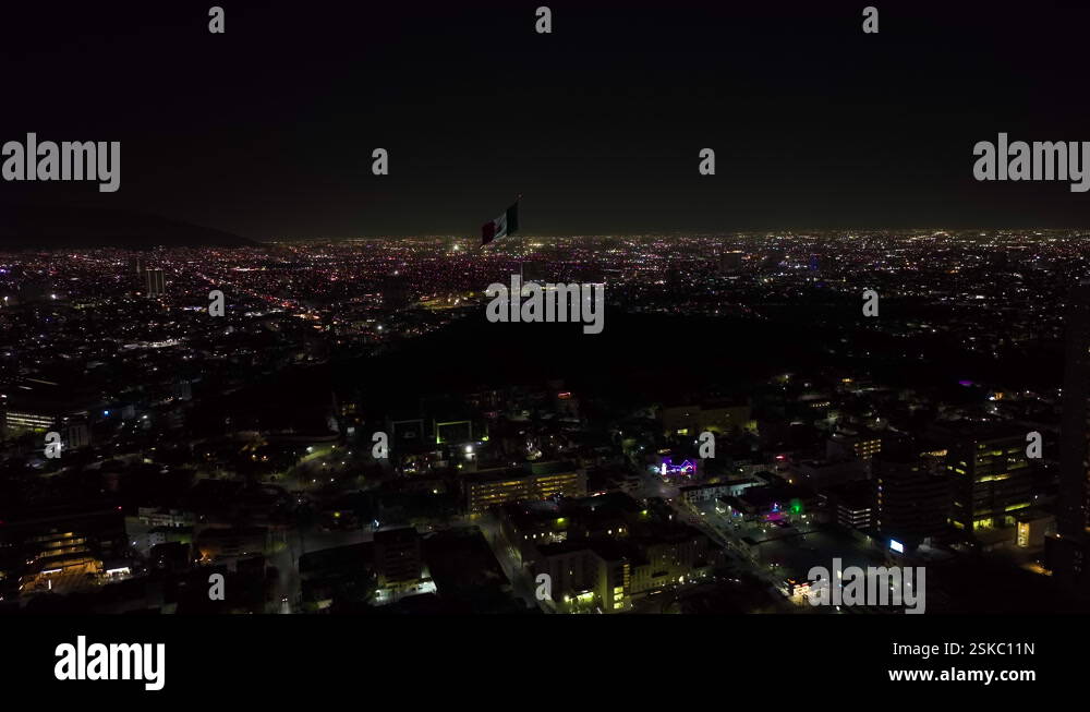 Aerial view around a mexican flag on top of the Cerro del Obispado ...