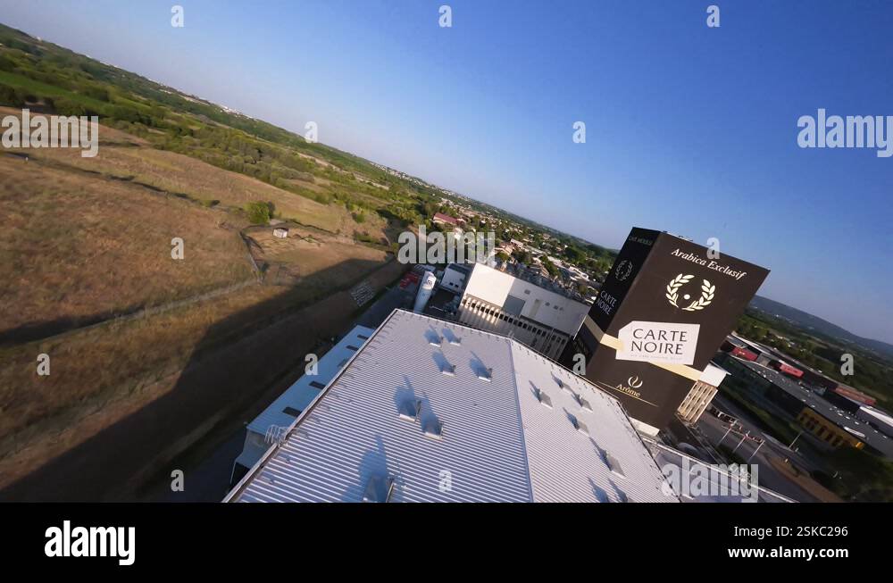 From a bird's-eye view, you can see the rooftops of buildings, trees ...