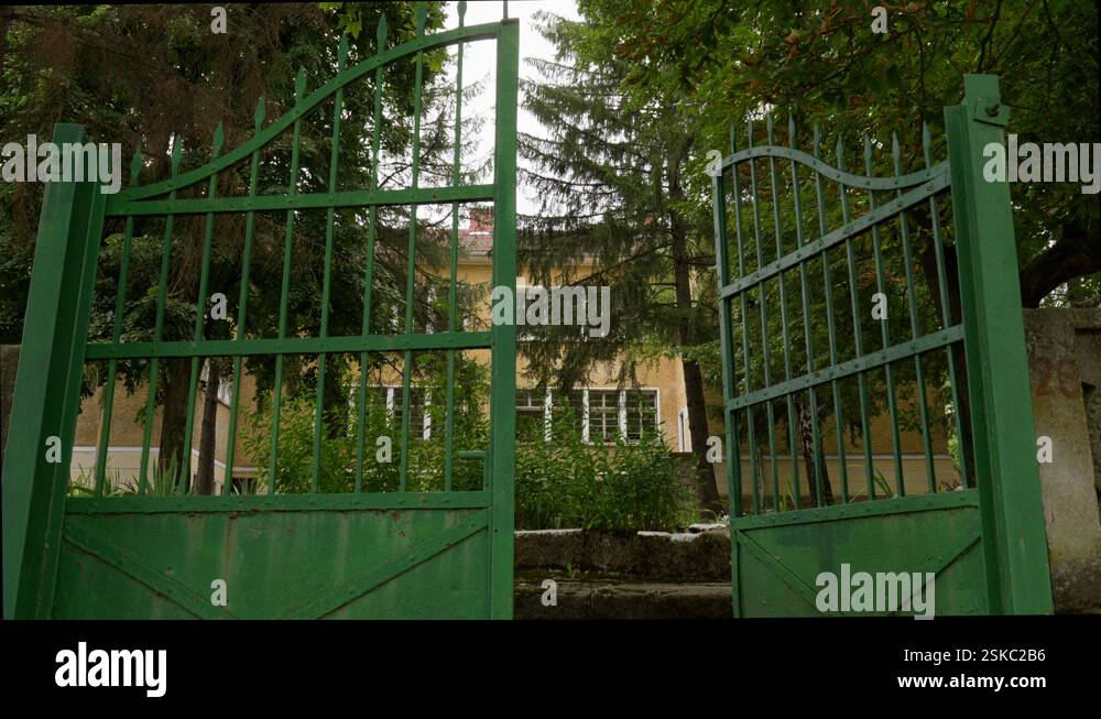 Green entrance gates to shabby Eastern European school building up ...