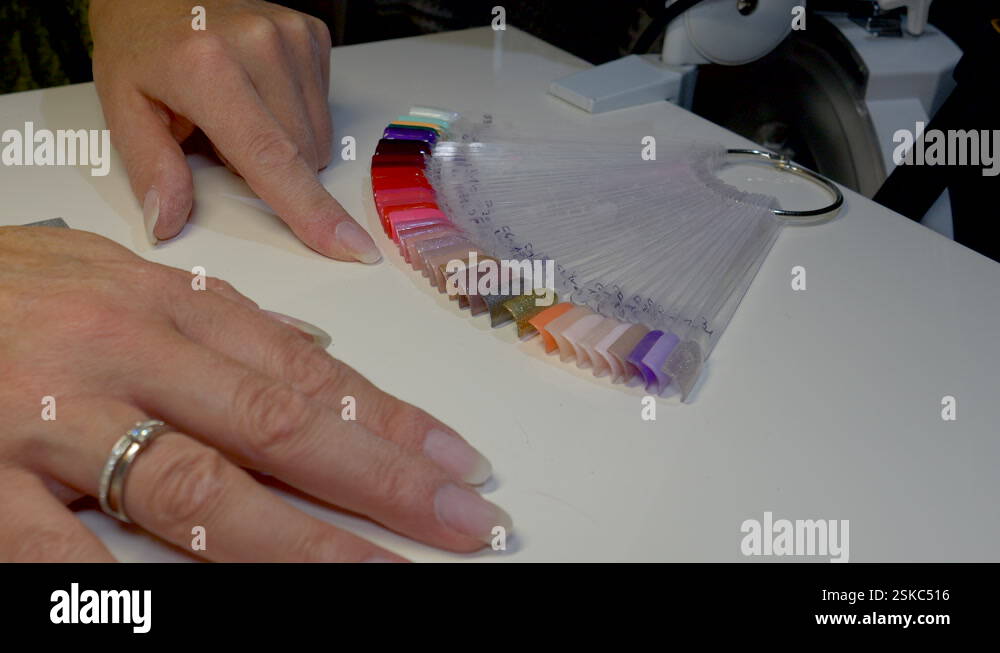 Finger of female person checking colors of color palette in nail Stock ...