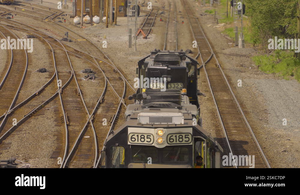 overhead view of a train engine as it slowly proceeds down the railroad ...