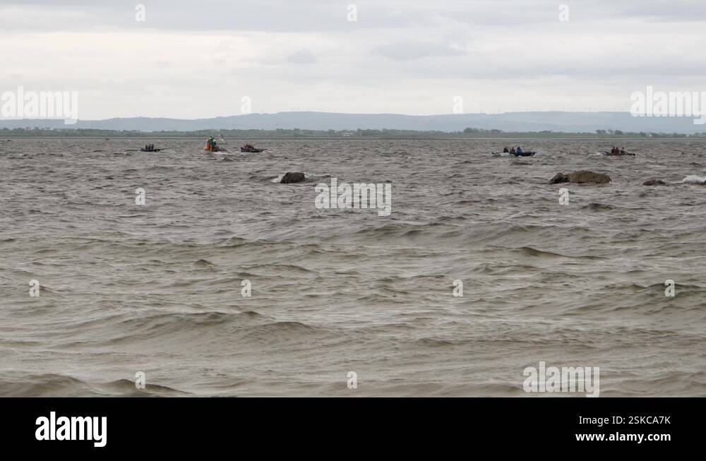 Currach boats rowing through open rocky ocean near ladies beach galway ...