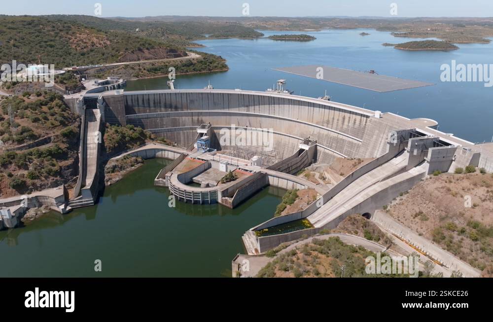 Circling above the expansive Alqueva Dam walls and solar farm floating ...