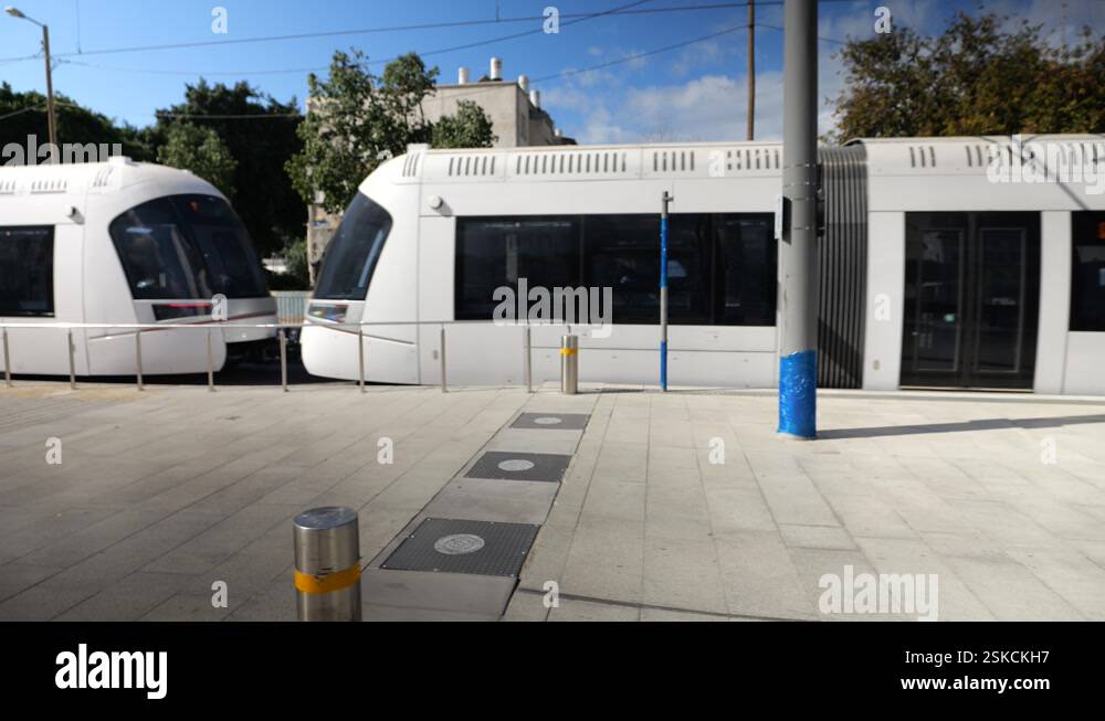 Light rail leaving a tram station, new public transportation line in ...