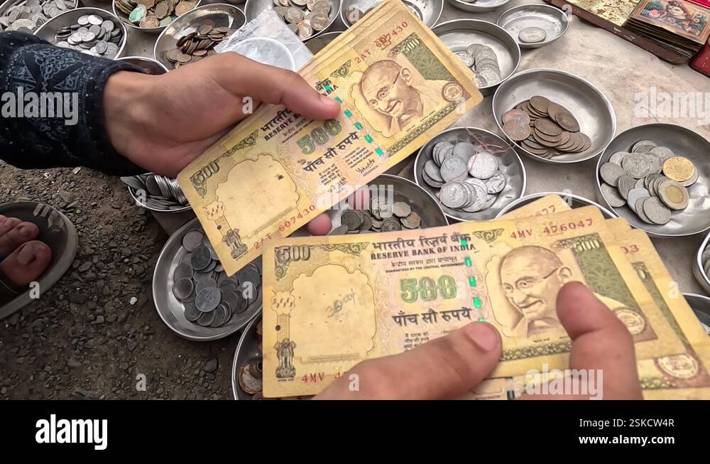 close-up scene of a man displaying old and vintage collectible currency ...