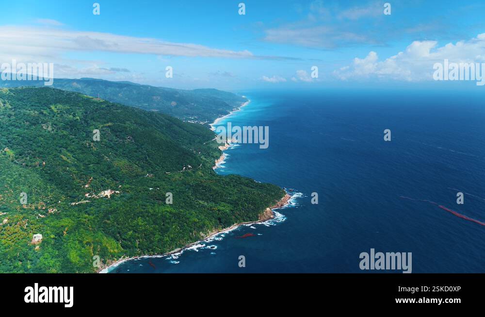 Ocean bay with blue water near green tropical mountainous peninsula ...