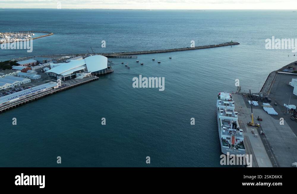 Aerial flight over Port area of Fremantle with docking industrial ship ...