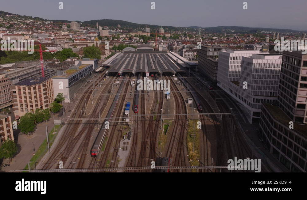 Backwards tracking of train leaving Hauptbahnhof. Aerial view of ...