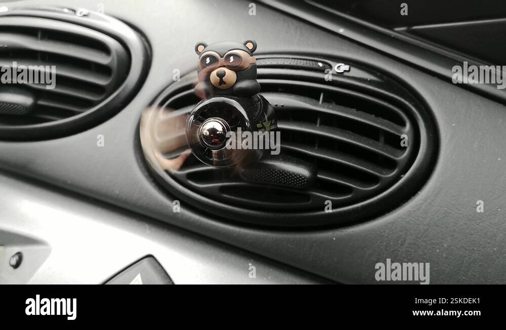 Teddy bear racing aircraft with fast spinning propeller on car interior ...