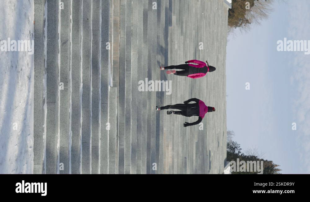 Vertical Screen: People running up on staircase in park Stock Video ...