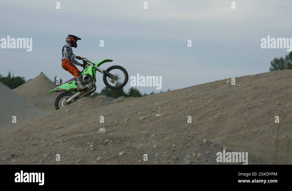 Motocross dirtbiker jumps natural step up in sand pit - summer fun with ...