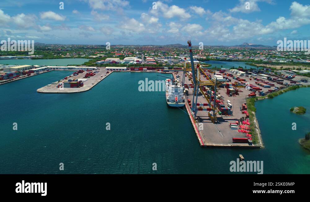 Shipping container port on Curacao island, drone descend tilt up, blue ...