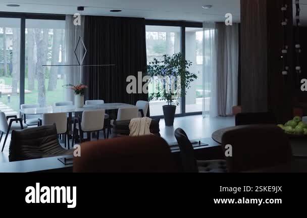 This stylish dining space features large windows that let in natural ...