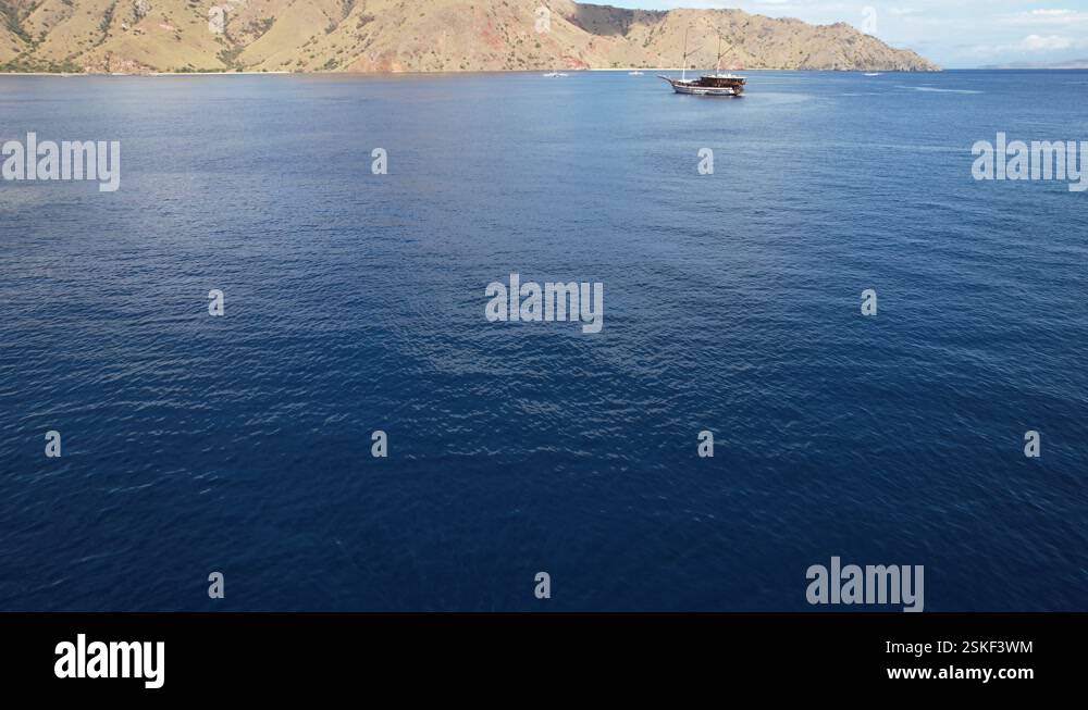 beautiful view of the stunning phinisi yacht overlooking the komodo ...