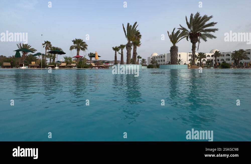 Low angle water surface POV of swimming pool of luxury holiday resort ...
