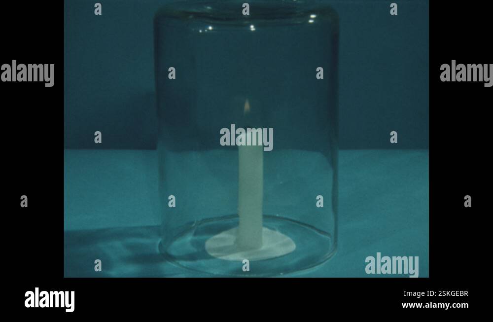 1960s: Flame slowly burns out on curled wick of candle in upside down ...