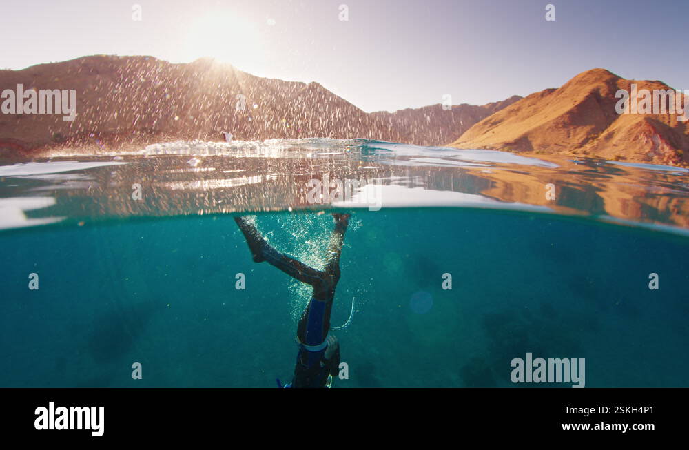 Duck dive freediving. Male freediver does duck dive and freedives in ...
