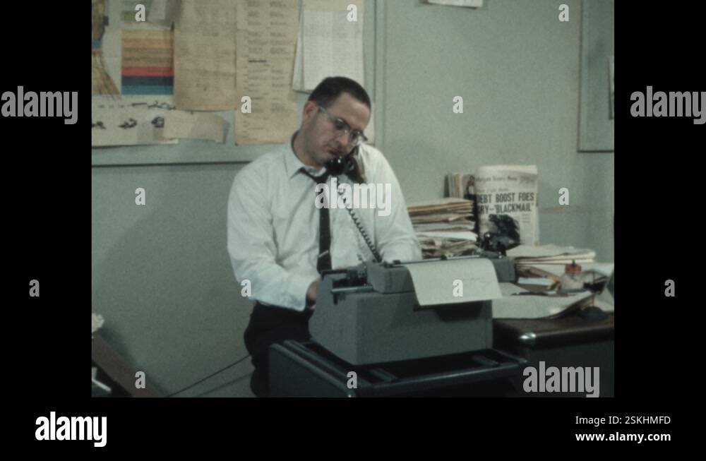 1960s: Office. Man speaks on telephone and types. Man hangs up. Man ...
