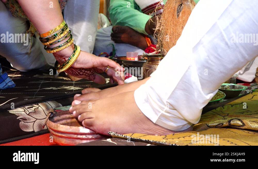 Applying Hindu Swastik on a groom egs in marriage ritual. Marathi ...