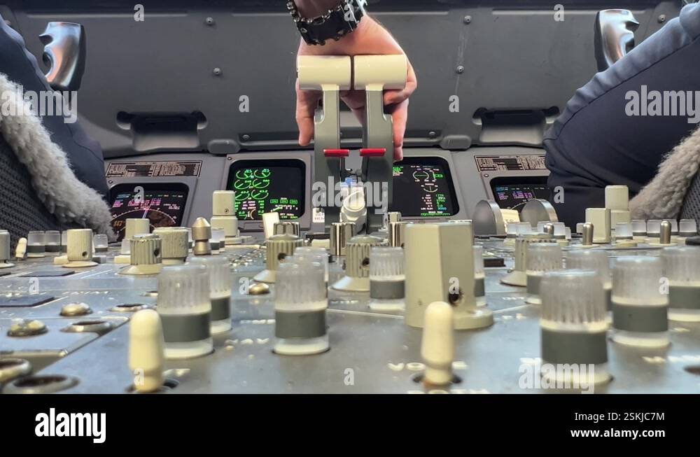 Low angle view inside a jet cockpit of the engine control panel while ...