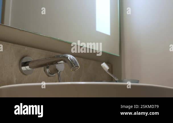 motion of asian male hand turning faucet off tap water from leaky ...