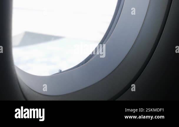 selective focusing of airplane's window while plane is flying over ...