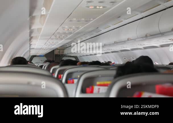 rear view of plane passenger seat inside aeroplane with selective ...