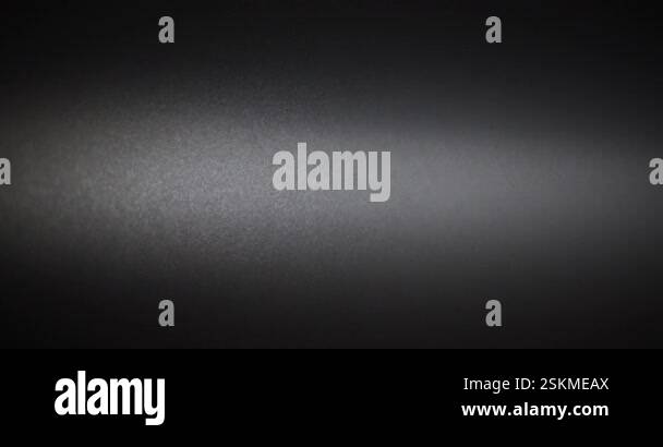 Floating dust particles become visible as they catch a beam of light ...