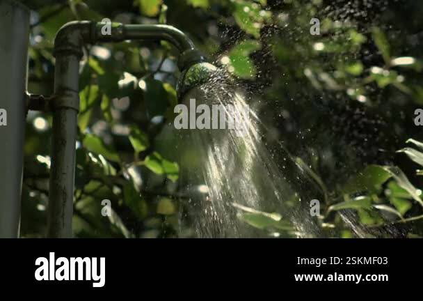 Water spraying from a showerhead in slow-motion at 1000 fps, capturing ...