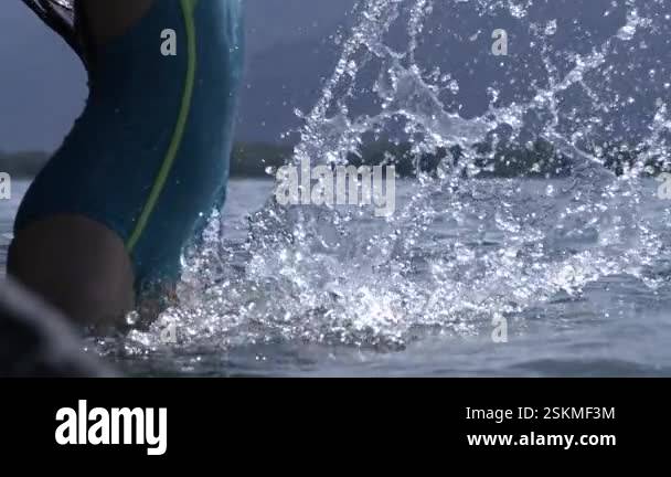 Little girl splashing in the lake, high-speed slow-motion capture ...