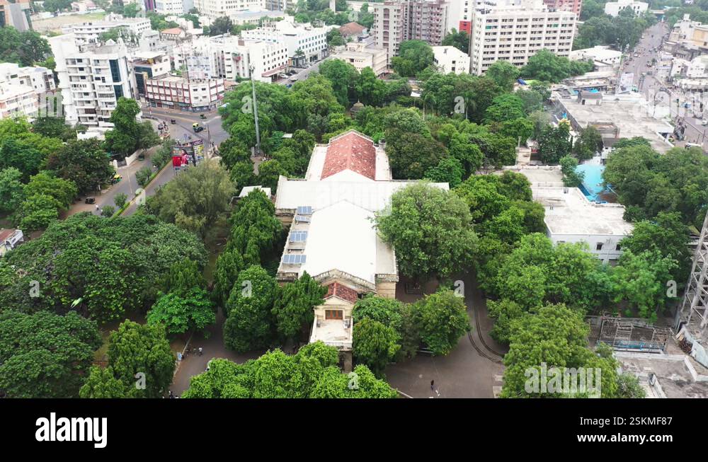 An aerial camera is moving forward over the Watson Museum and lots of ...