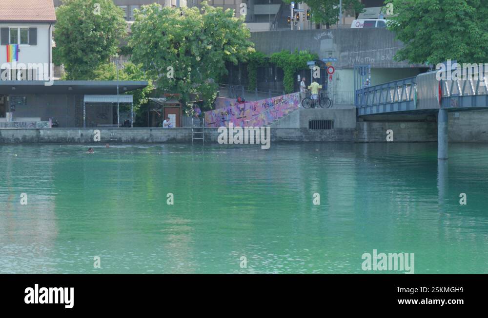 Pan Shot from Water Level of Pedestrian Bridge over Canal in Zurich ...