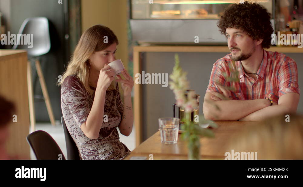 People drinking tea talking to each other offline. Real life people ...