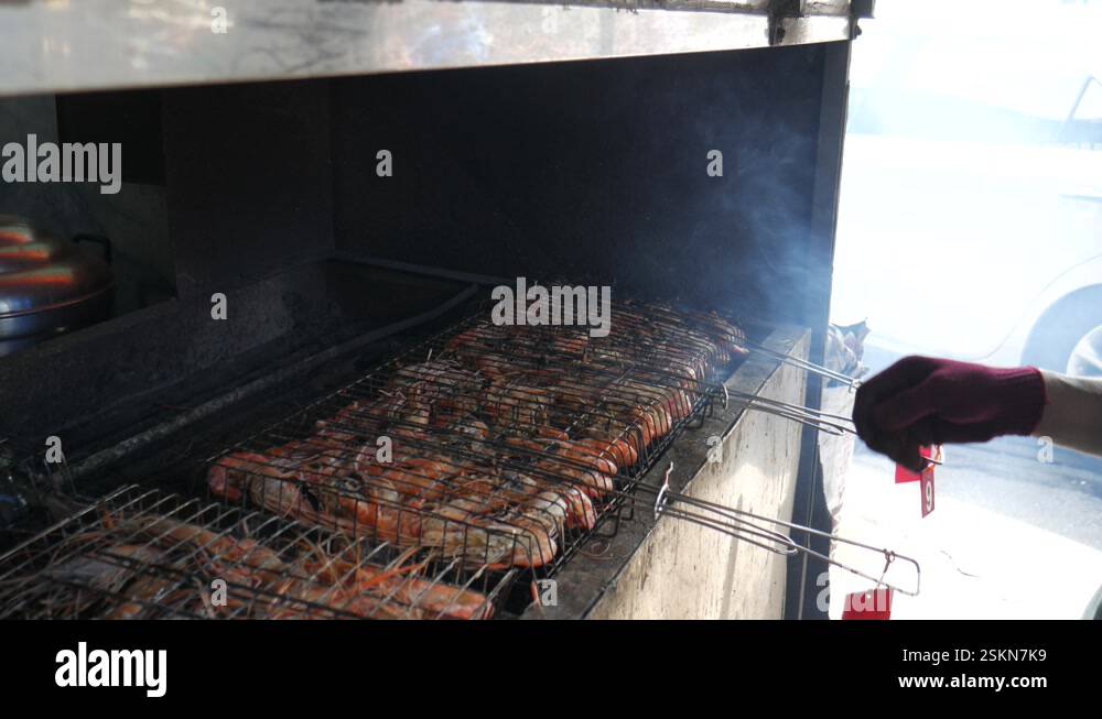 grill cooking river prawns in cage on hot charcoal at thailand pattaya ...