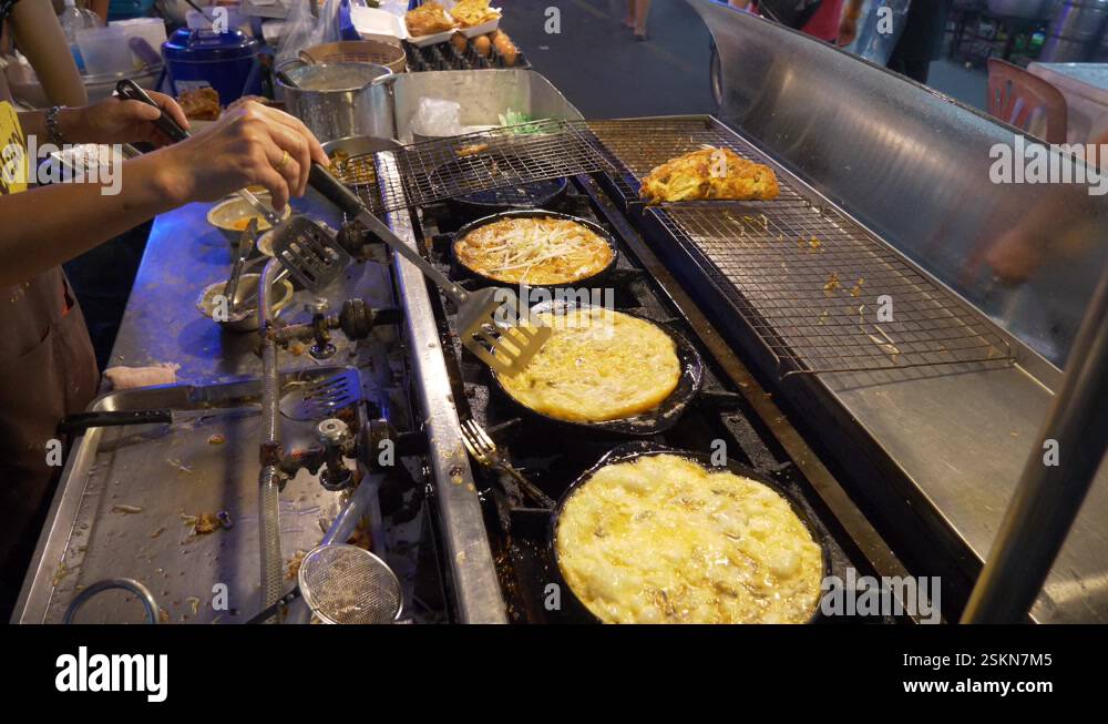 pan fried oyster pan cake omelette in thailand night market street food ...