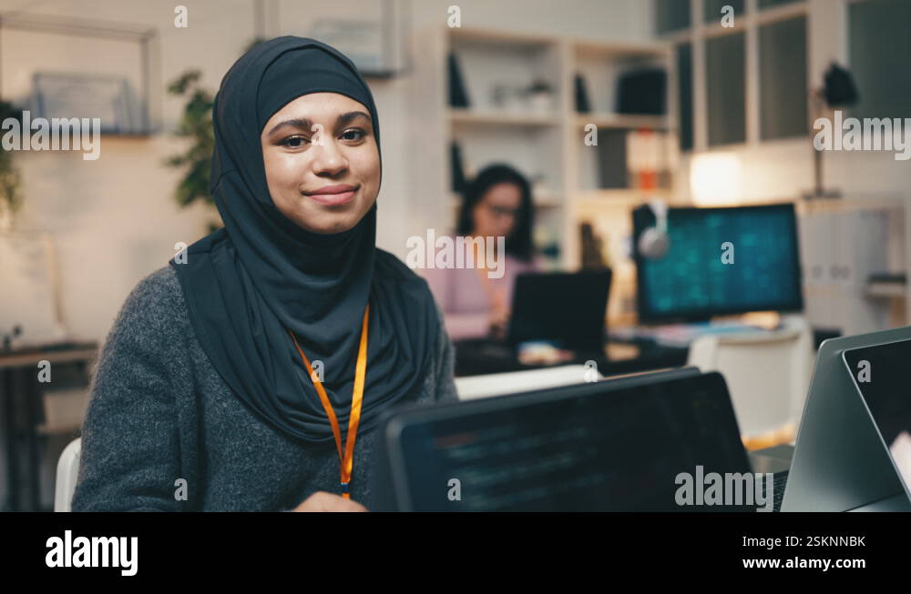 Portrait of Muslim woman in hijab working as a programmer, IT ...