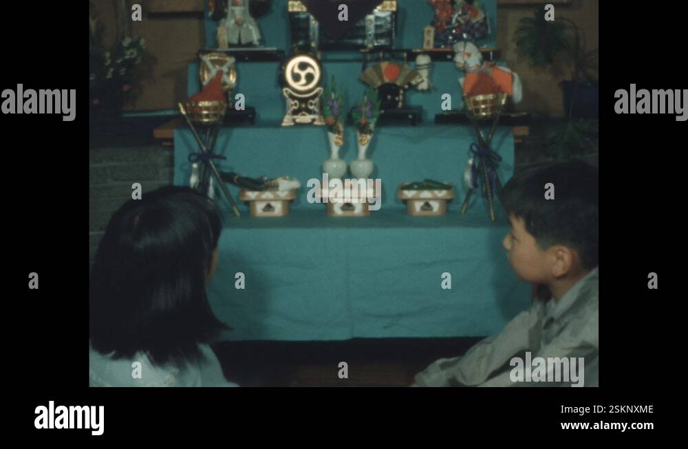 Japan 1960s: Boy and girl sit before a Children's Day display of ...