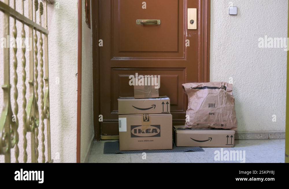 Amazon and Ikea delivery packages are placed in front of a buyer's door ...
