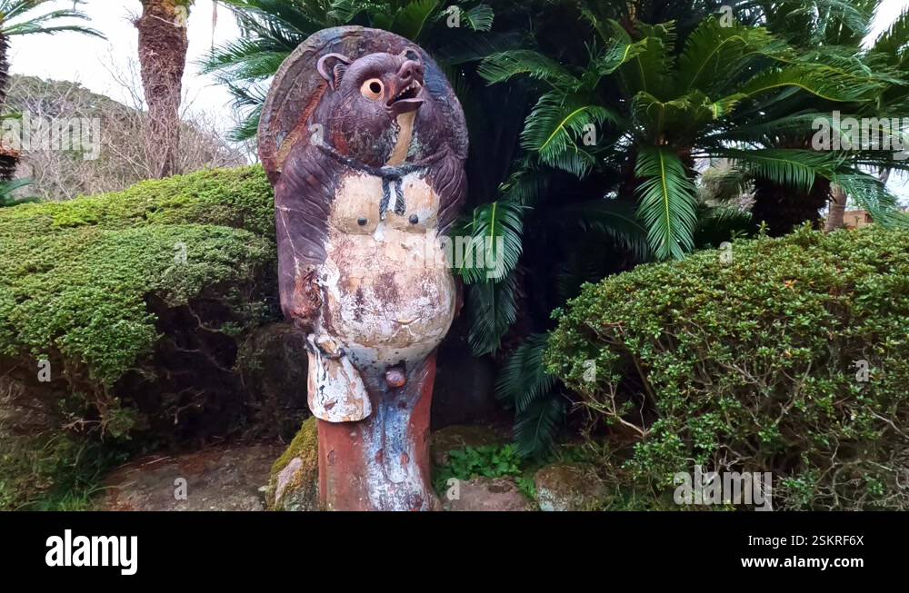 Big Japanese Tanuki statue in a traditional garden within a shrine ...