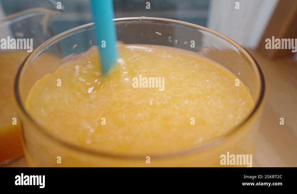 I stir the pulp in the glass of orange juice with a straw and take a ...